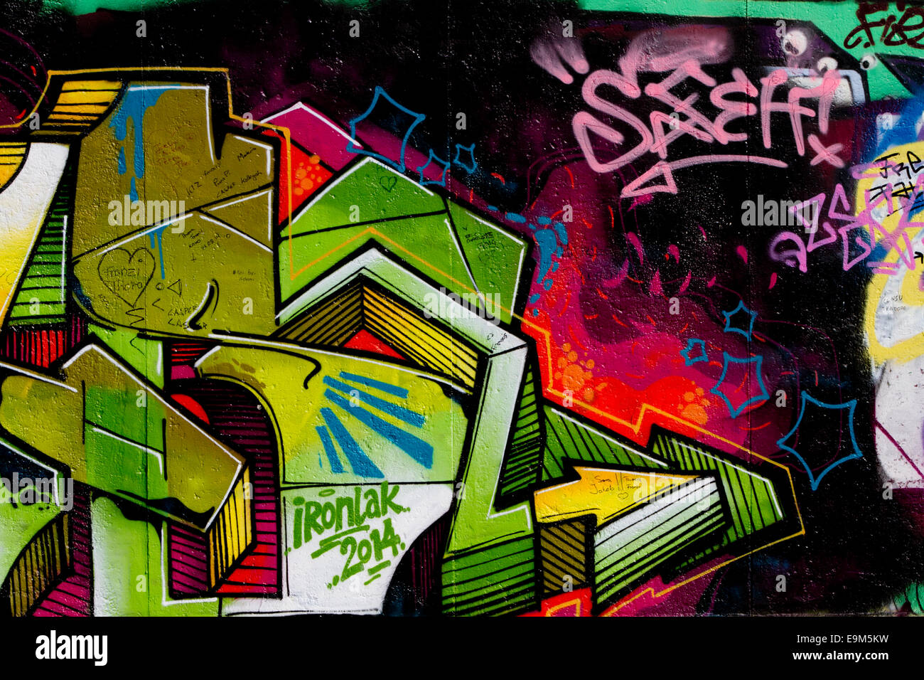 Graffiti street art Berlin Wall urban tags colour Stock Photo - Alamy