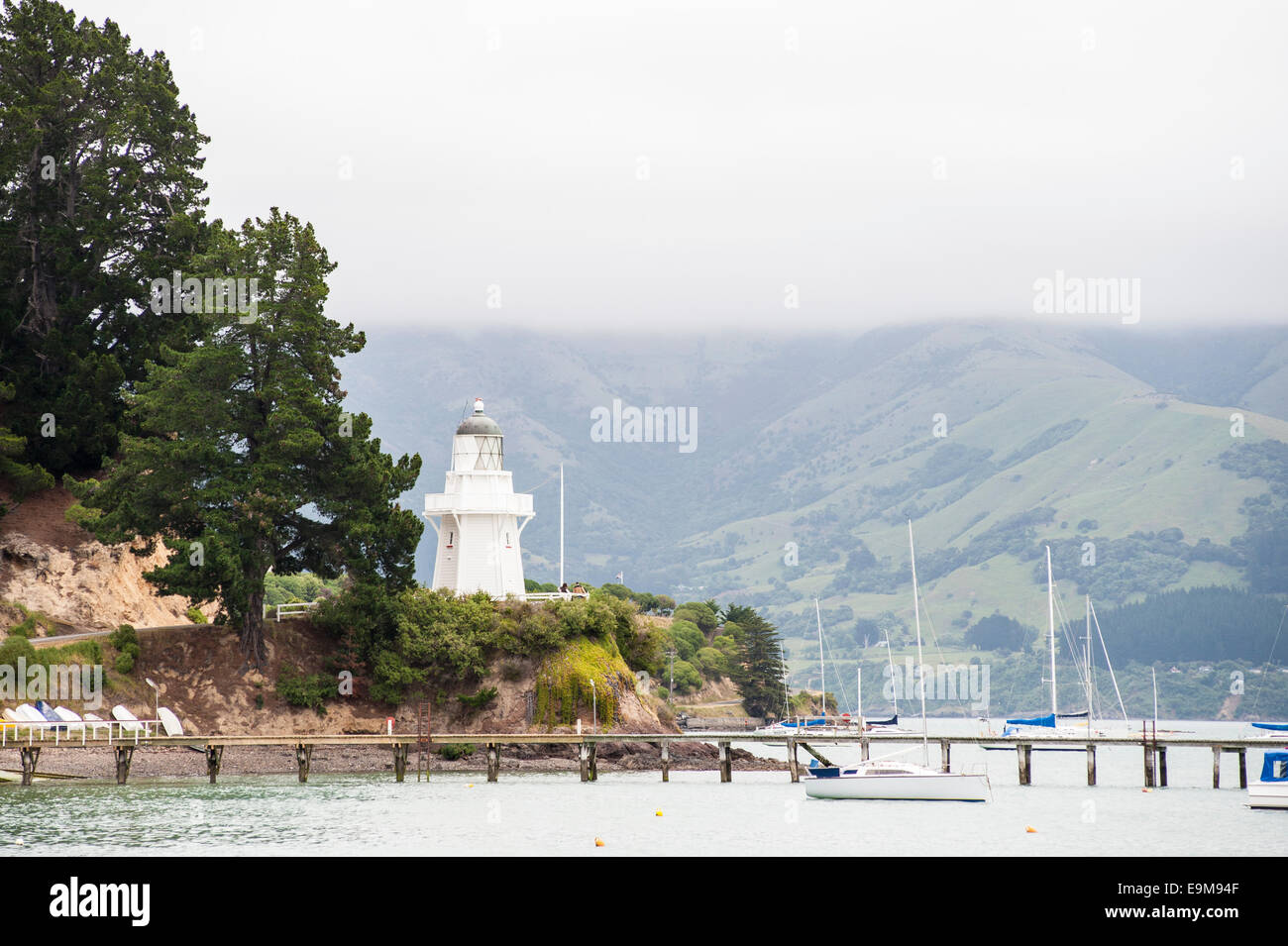 Jetty and lighthouse at Akaroa, New Zealand Stock Photo - Alamy