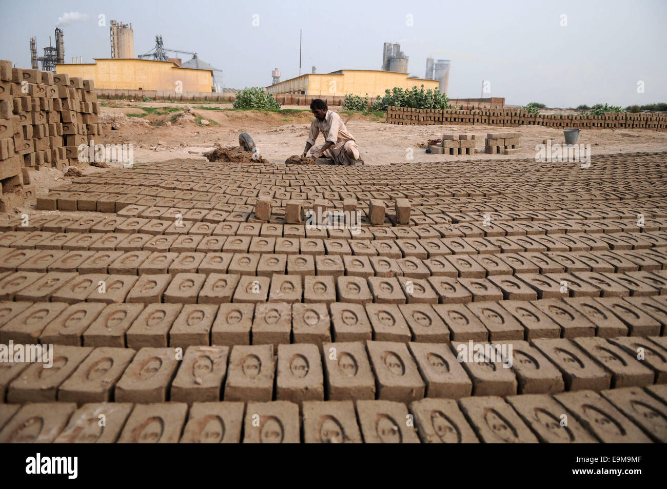 Multan. 30th Oct, 2014. A laborer works at a brick factory in central ...