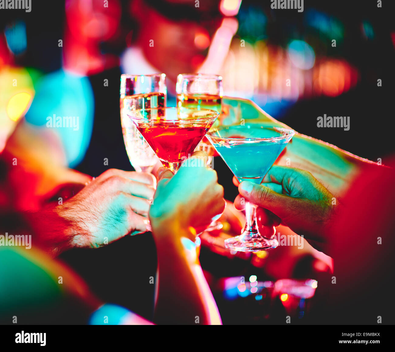 Hands of friends with cocktails making toast at party Stock Photo - Alamy
