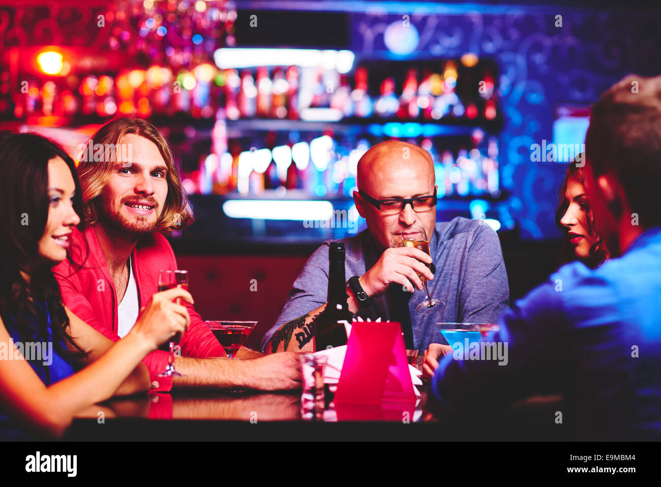 Friendly people with drinks spending time in the bar Stock Photo - Alamy