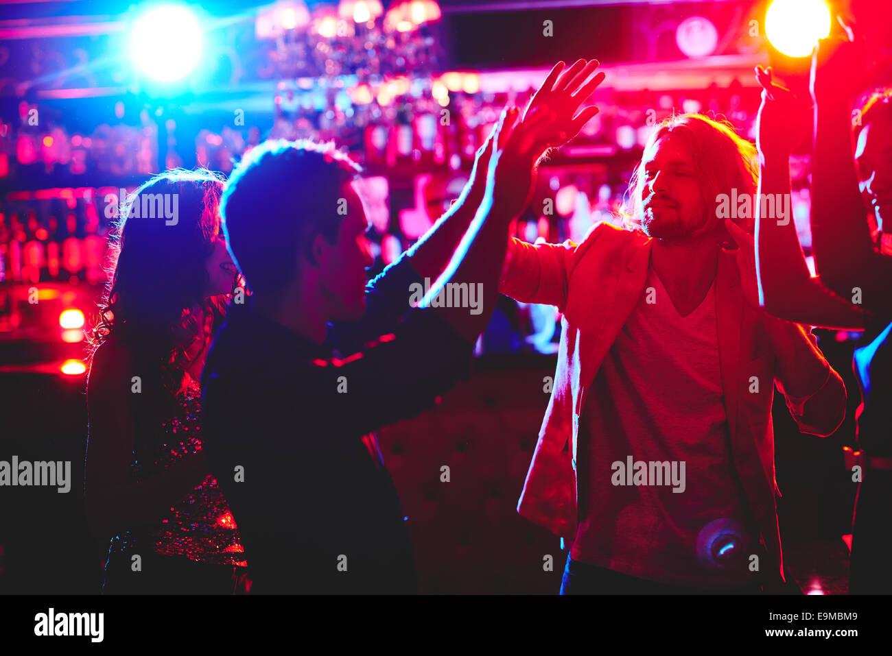 Group of happy friends dancing in nightclub Stock Photo - Alamy