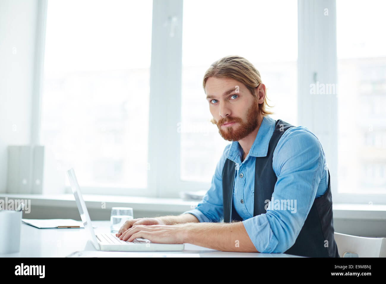 Young employee typing at workplace Stock Photo - Alamy