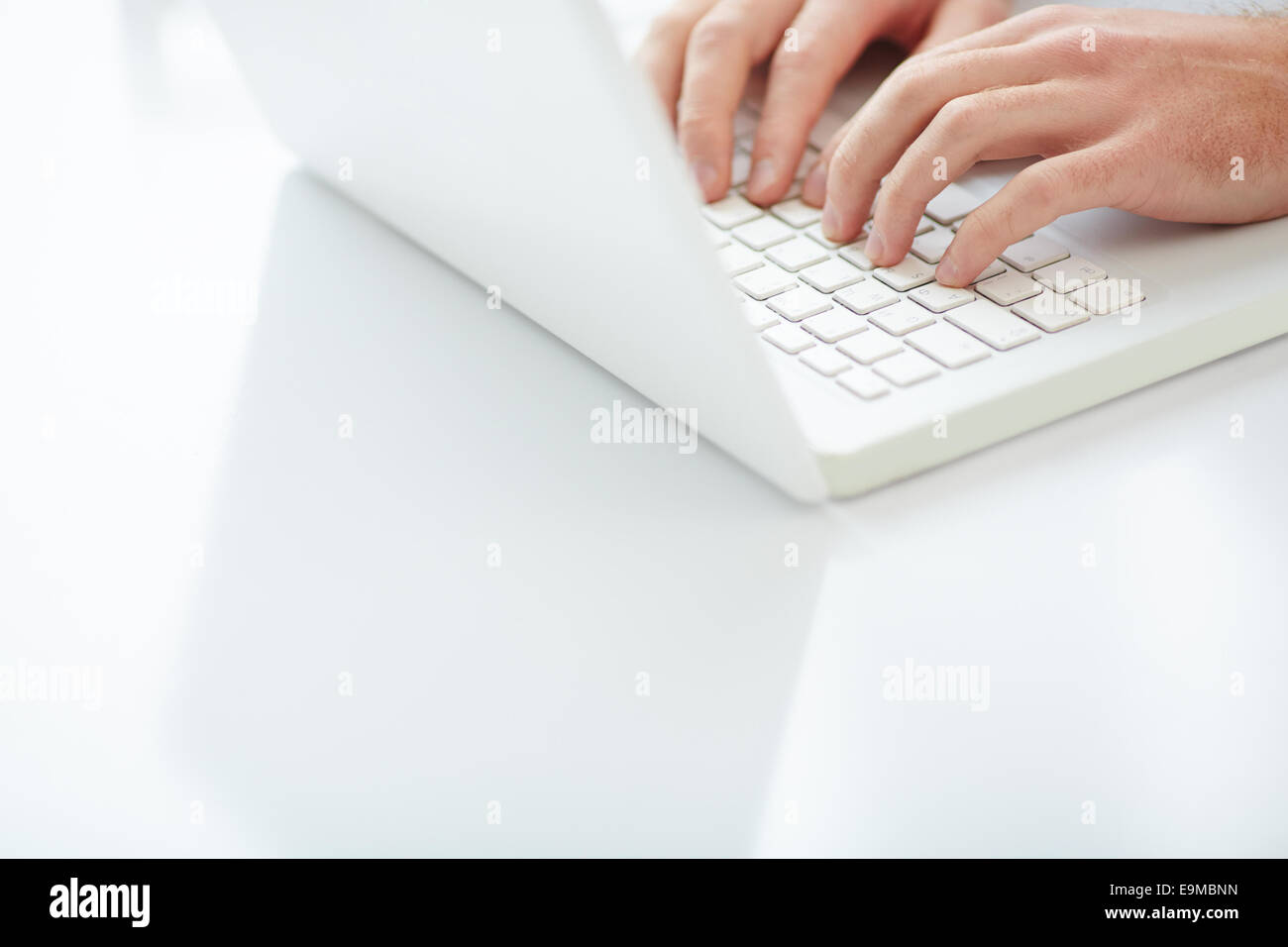 Fingers of businessman touching laptop keys Stock Photo - Alamy
