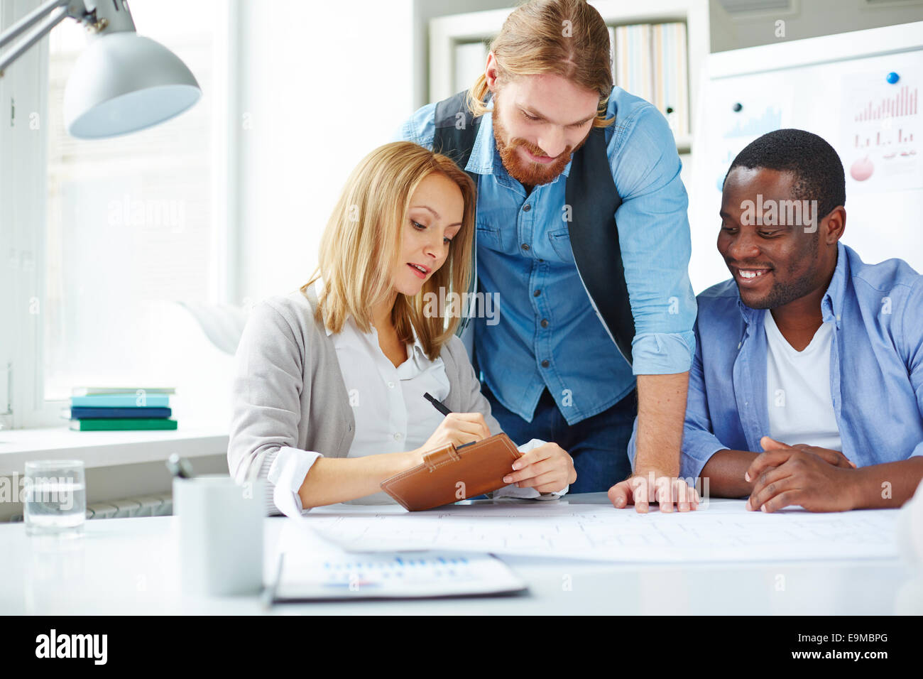 Female secretary writing down plan or description of new project Stock ...