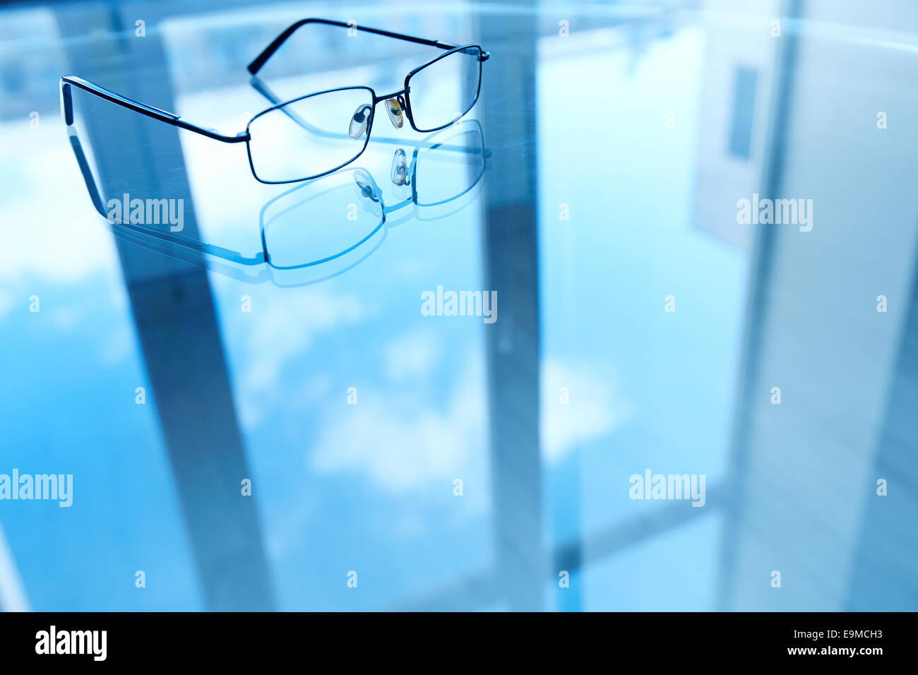 Eyeglasses on workplace and its reflection Stock Photo - Alamy