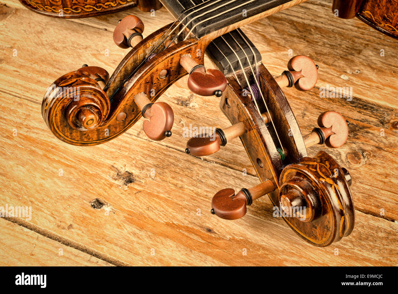 Necks of a violin and a viola on a wooden background Stock Photo - Alamy