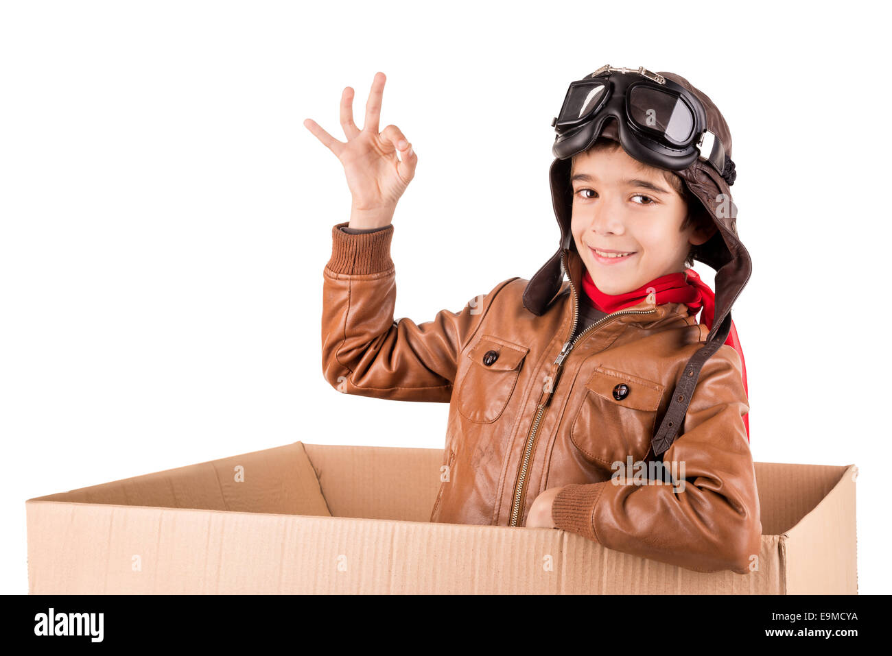 Young boy pilot flying a cardboard box isolated in white Stock Photo ...