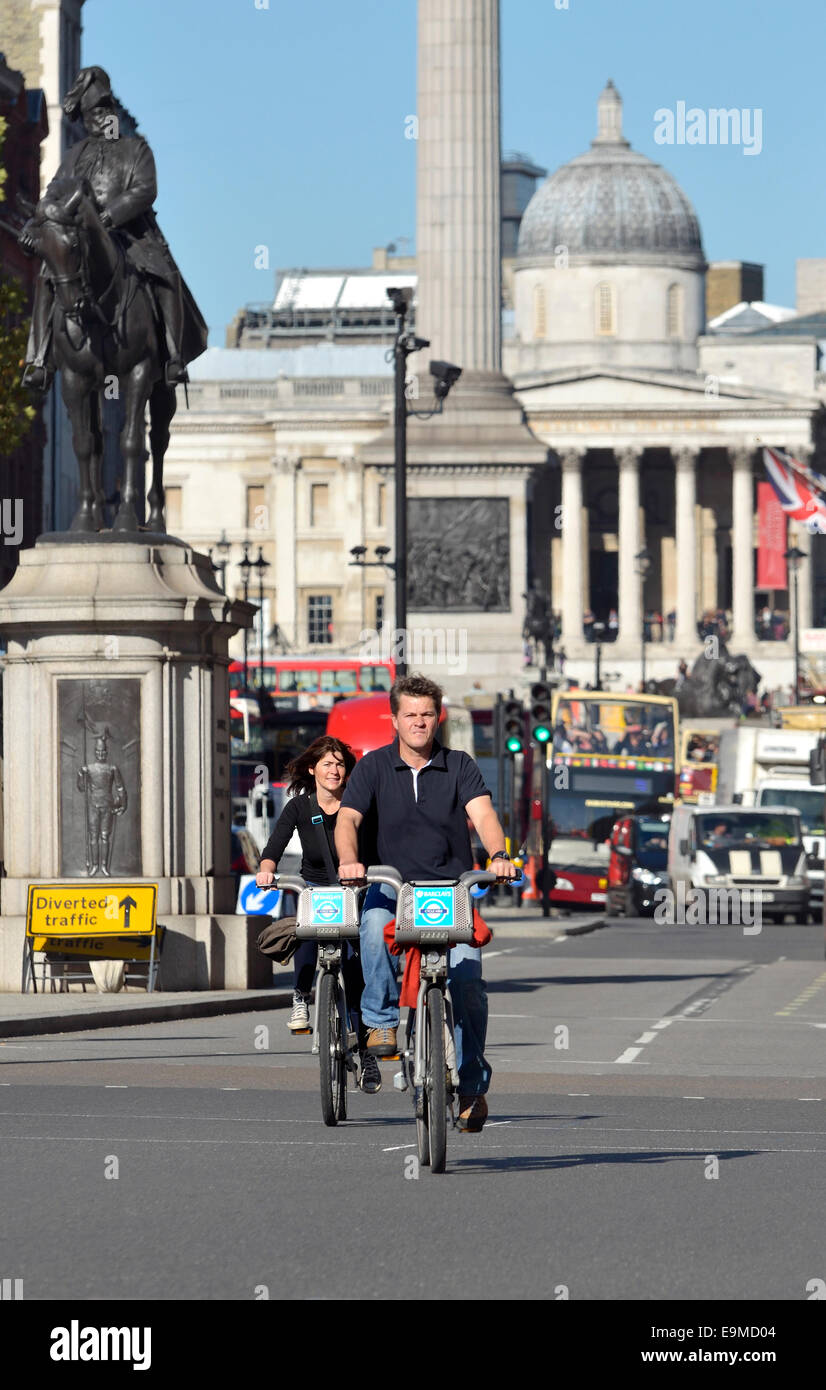 London, England, UK. Couple riding 'Boris Bikes' in Whitehall Stock ...