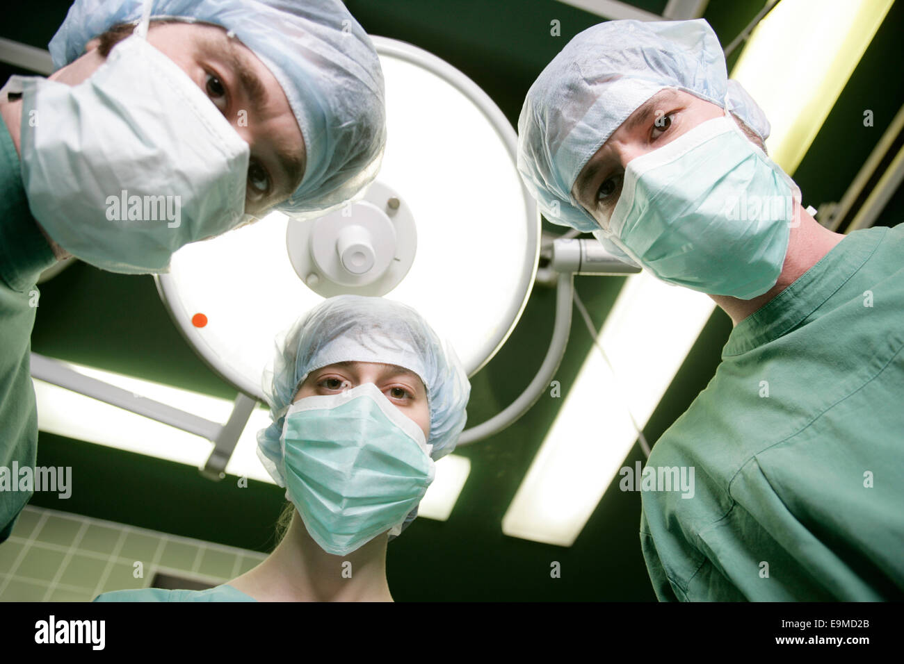Three surgeons looking down Stock Photo - Alamy