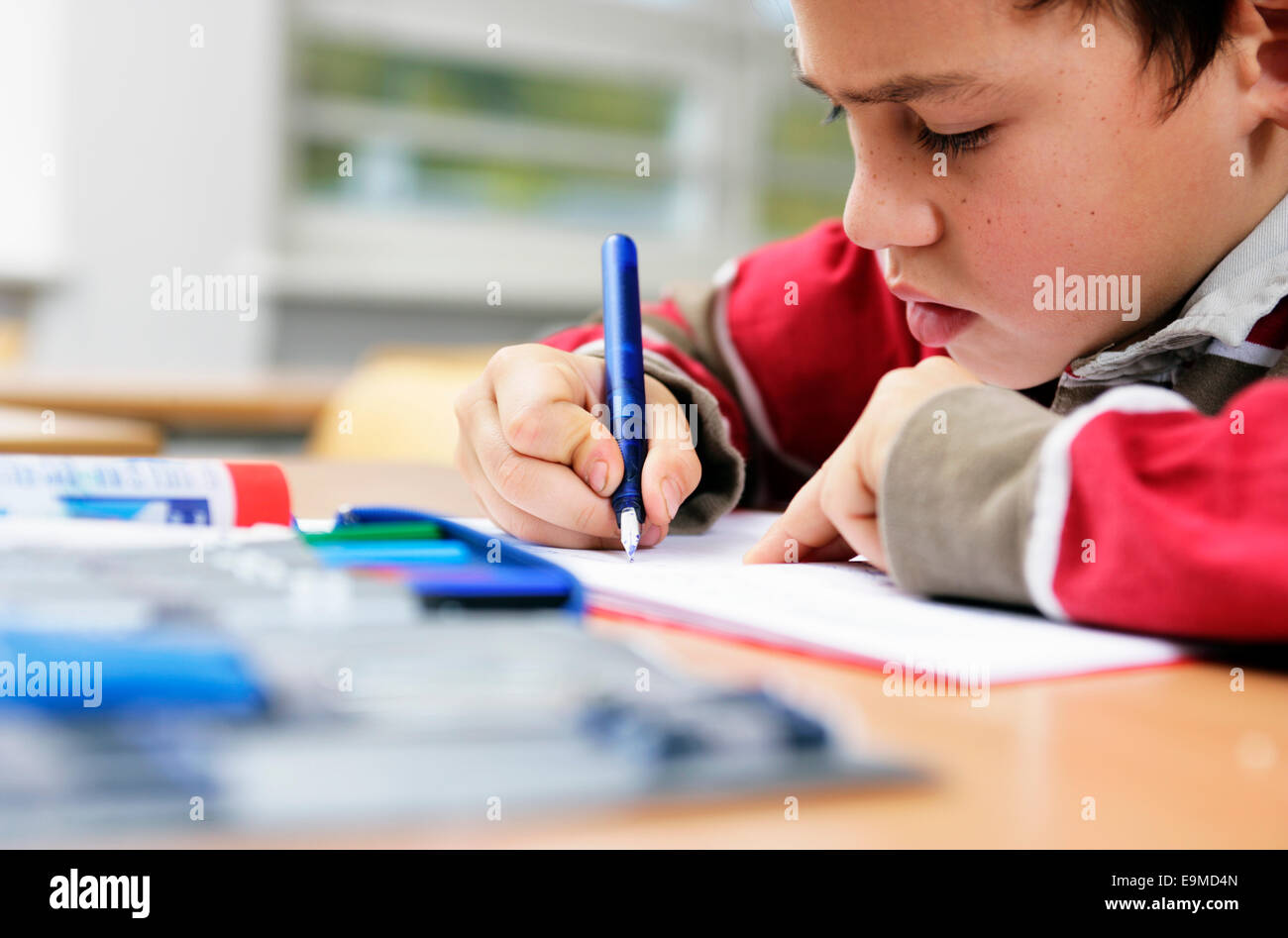 A small boy writing Stock Photo - Alamy
