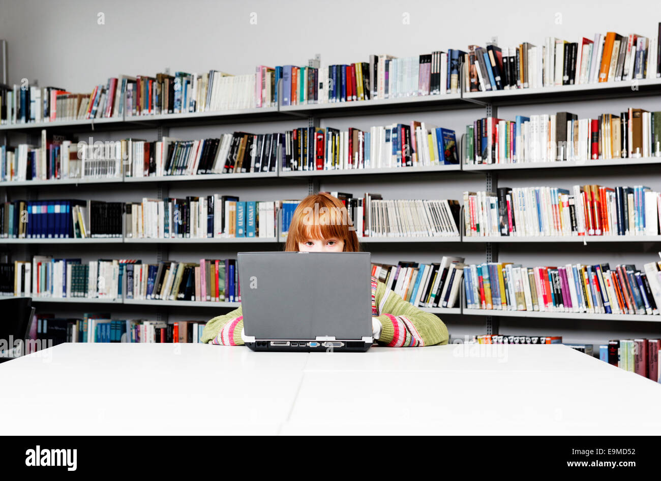 Girl in a library on laptop hi-res stock photography and images - Alamy