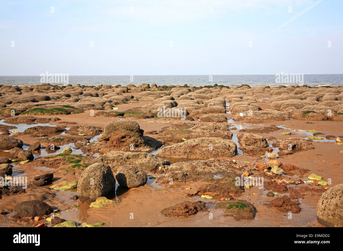 A view of carstone rocks and boulders on the beach at Hunstanton ...