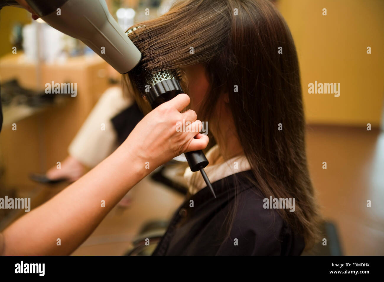 A woman having her hair styled at a salon Stock Photo - Alamy