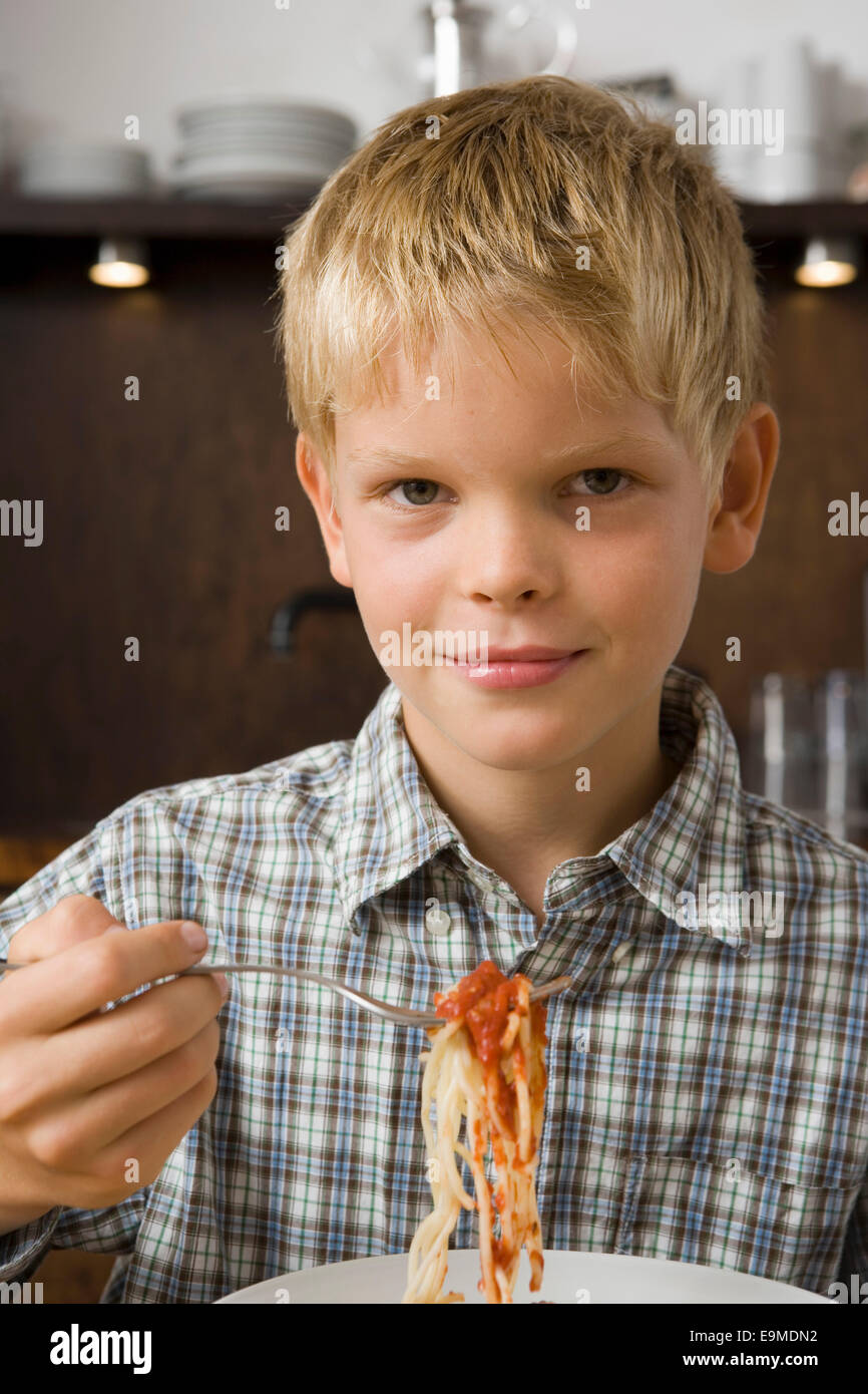 Boy eating spaghetti Bolognese Stock Photo - Alamy