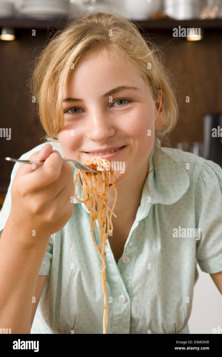 Blond girl eating spaghetti tomato hi-res stock photography and images ...