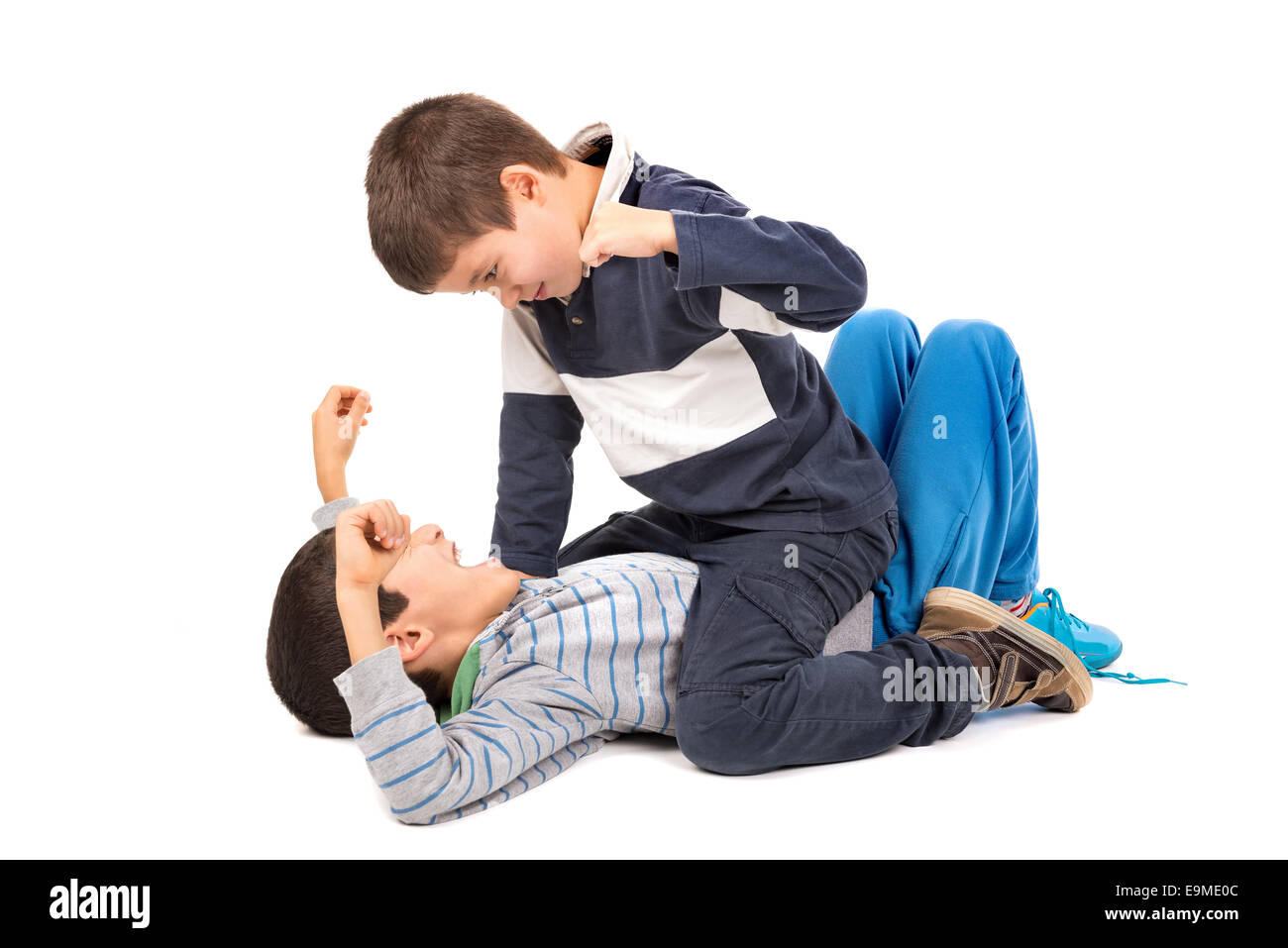 Young boys fighting isolated in white Stock Photo - Alamy