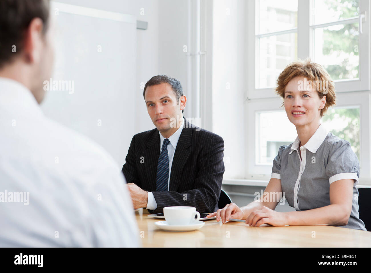 Business people sitting at a conference table having a meeting Stock ...