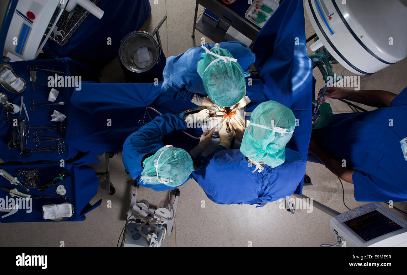 High angle view of a surgery team operating on a patient Stock Photo ...