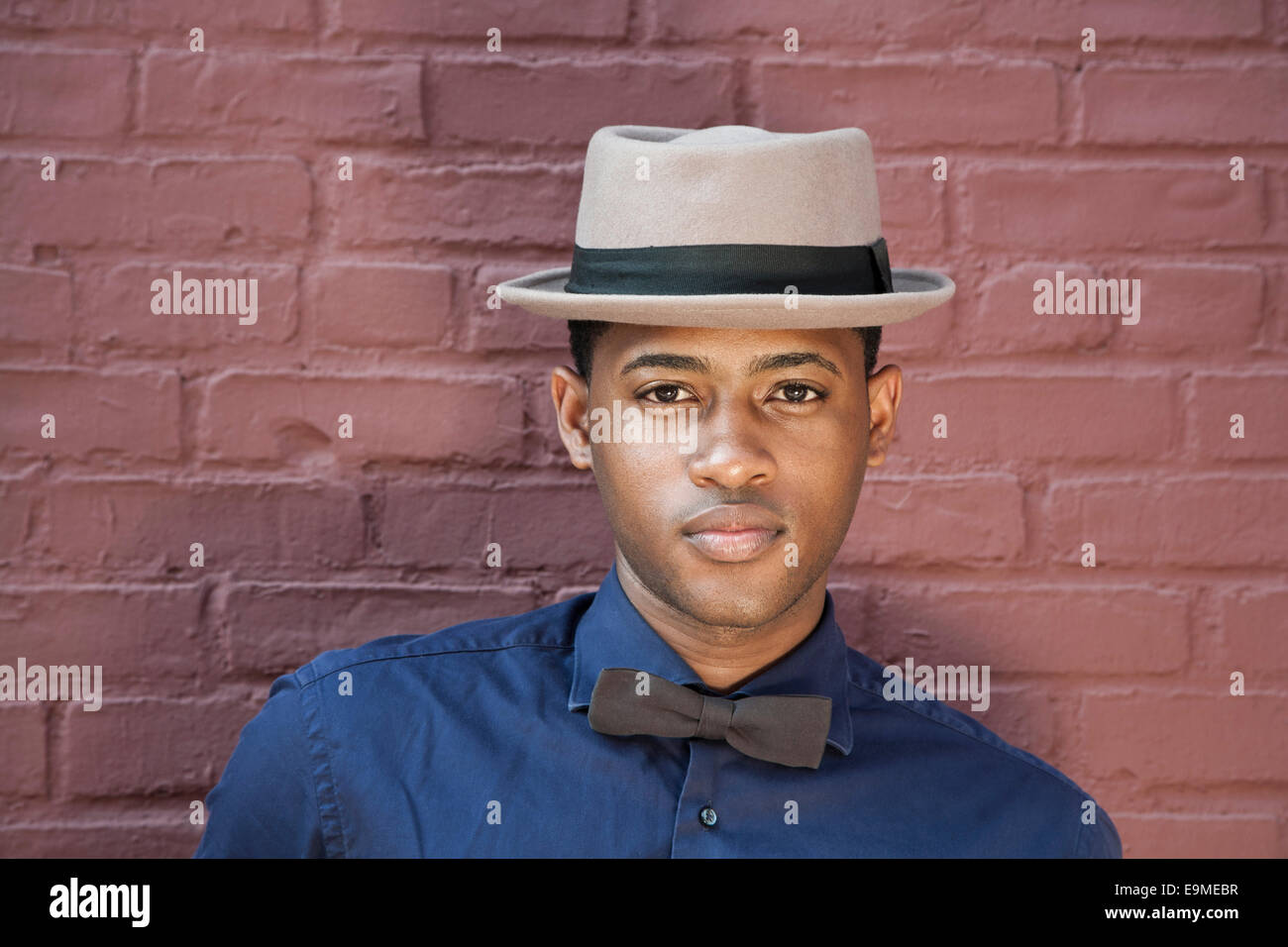 A young black man wearing bow tie and hat, close-up Stock Photo - Alamy