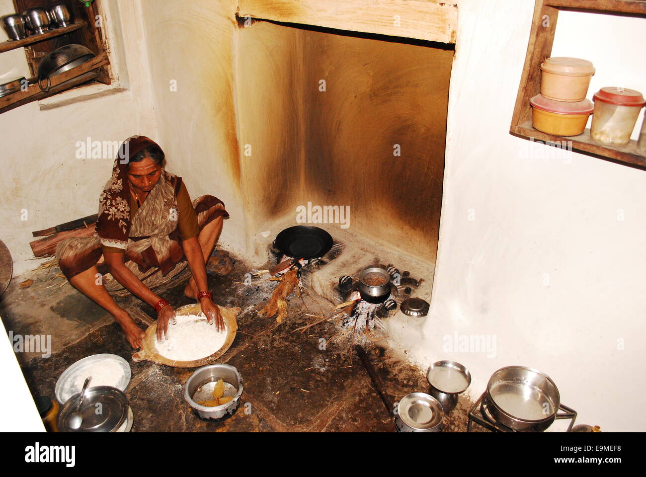 A woman cooks a meal in a village Stock Photo - Alamy