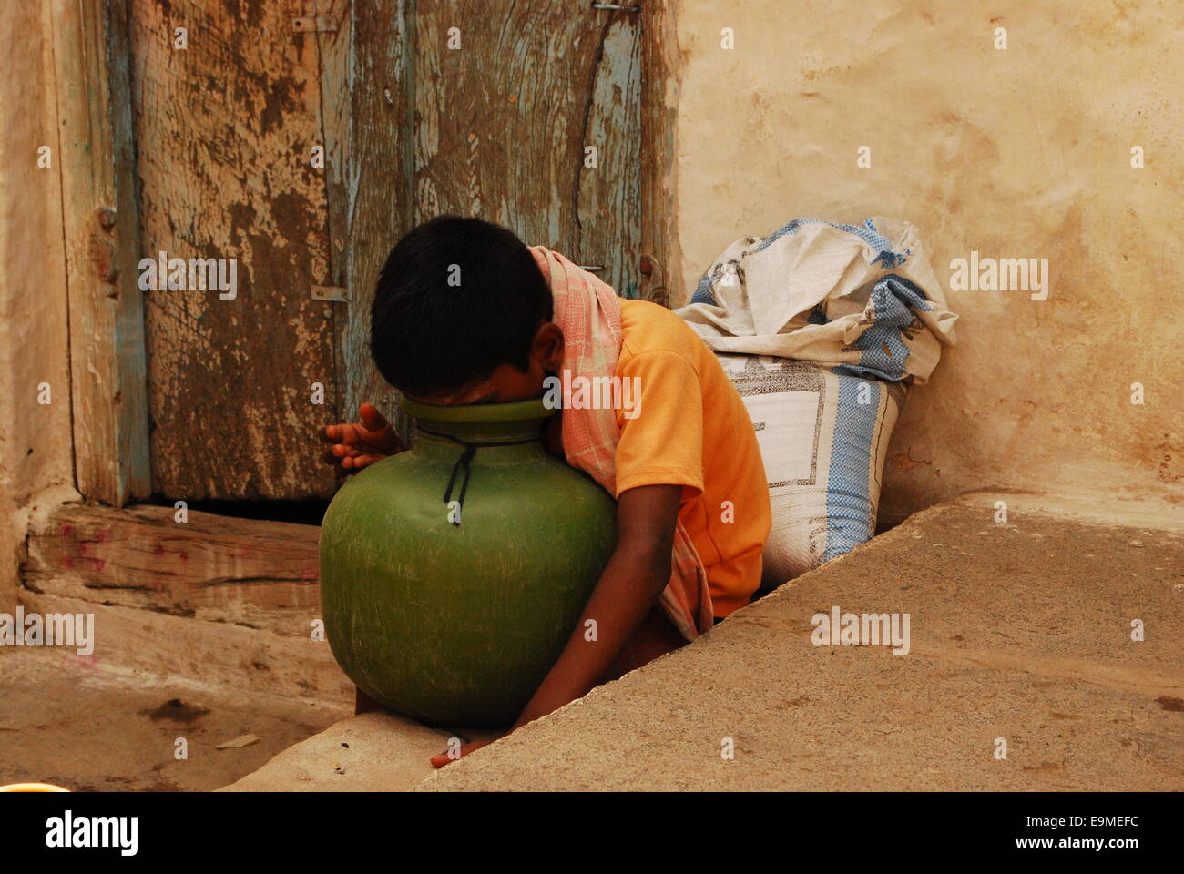 A boy with his face in a jar Stock Photo - Alamy