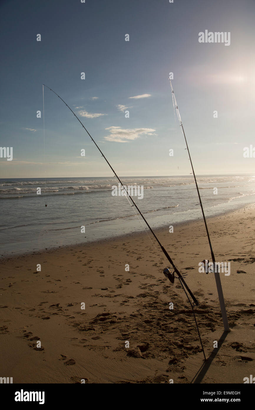 Fishing rods in sand on beach Stock Photo - Alamy