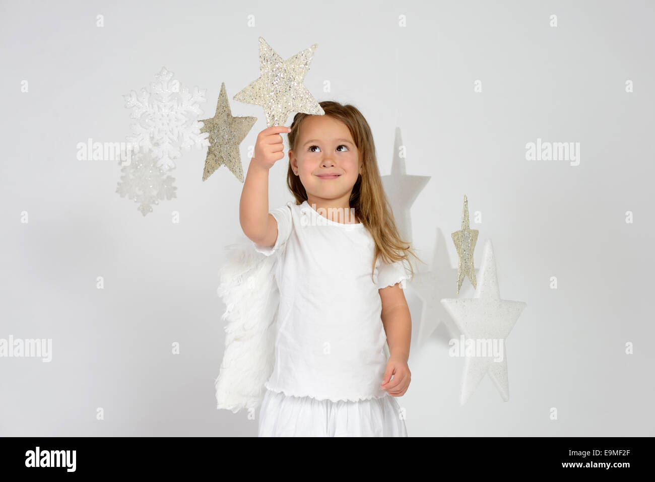 Child, girl wearing an angel costume with stars, Christmas, festive ...