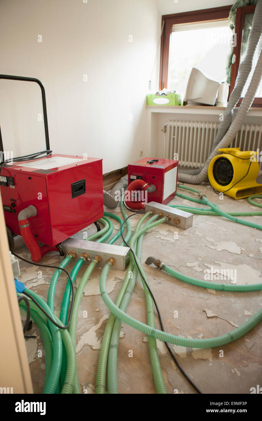 Tubes and machines in room under renovation Stock Photo - Alamy