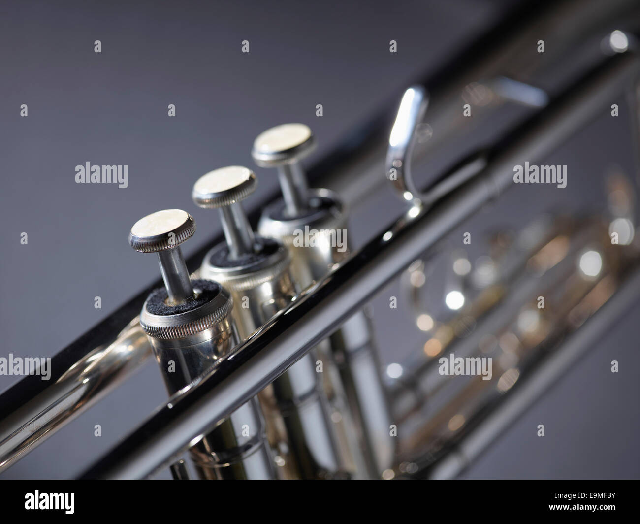 Close-up of trumpet against gray background Stock Photo - Alamy