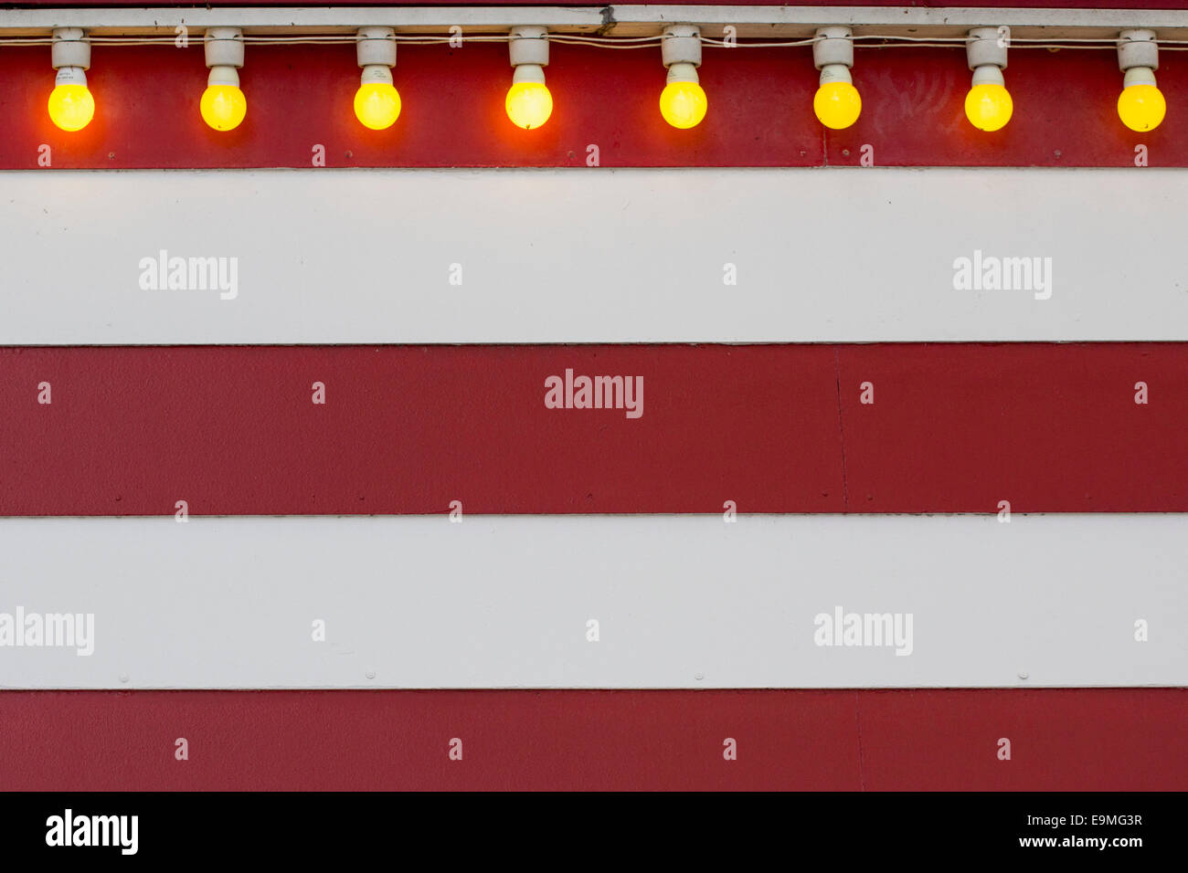 Lit light bulbs on striped wall Stock Photo - Alamy