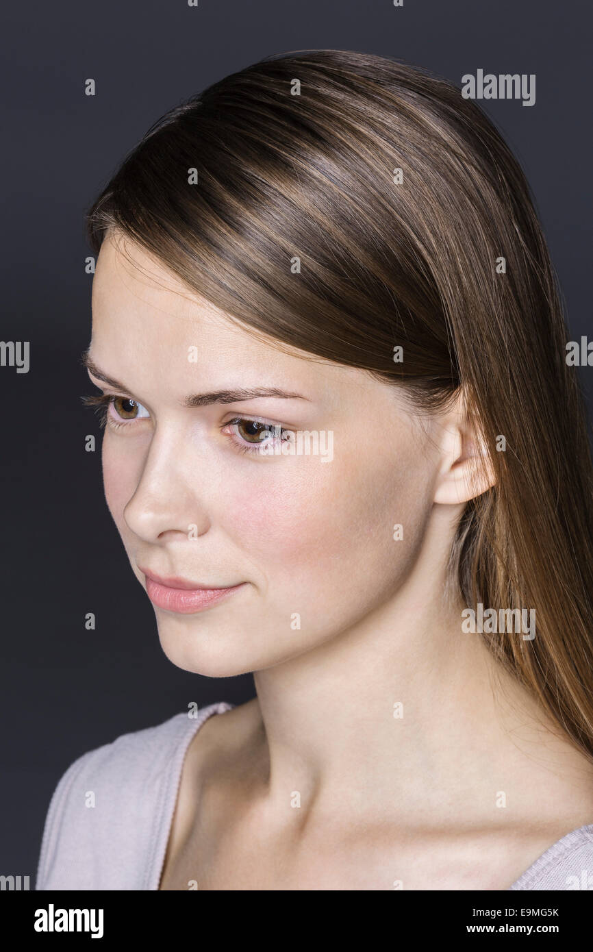 Close-up of thoughtful young woman against black background Stock Photo ...