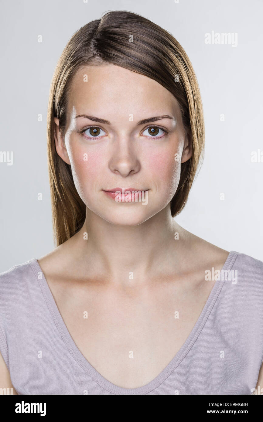Close-up portrait of beautiful young woman against white background ...