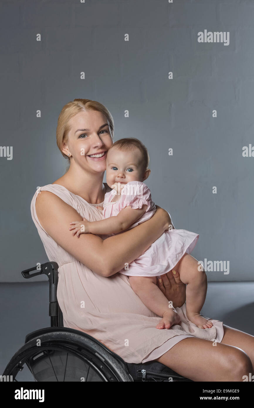 Mother in wheelchair holding baby hi-res stock photography and images ...