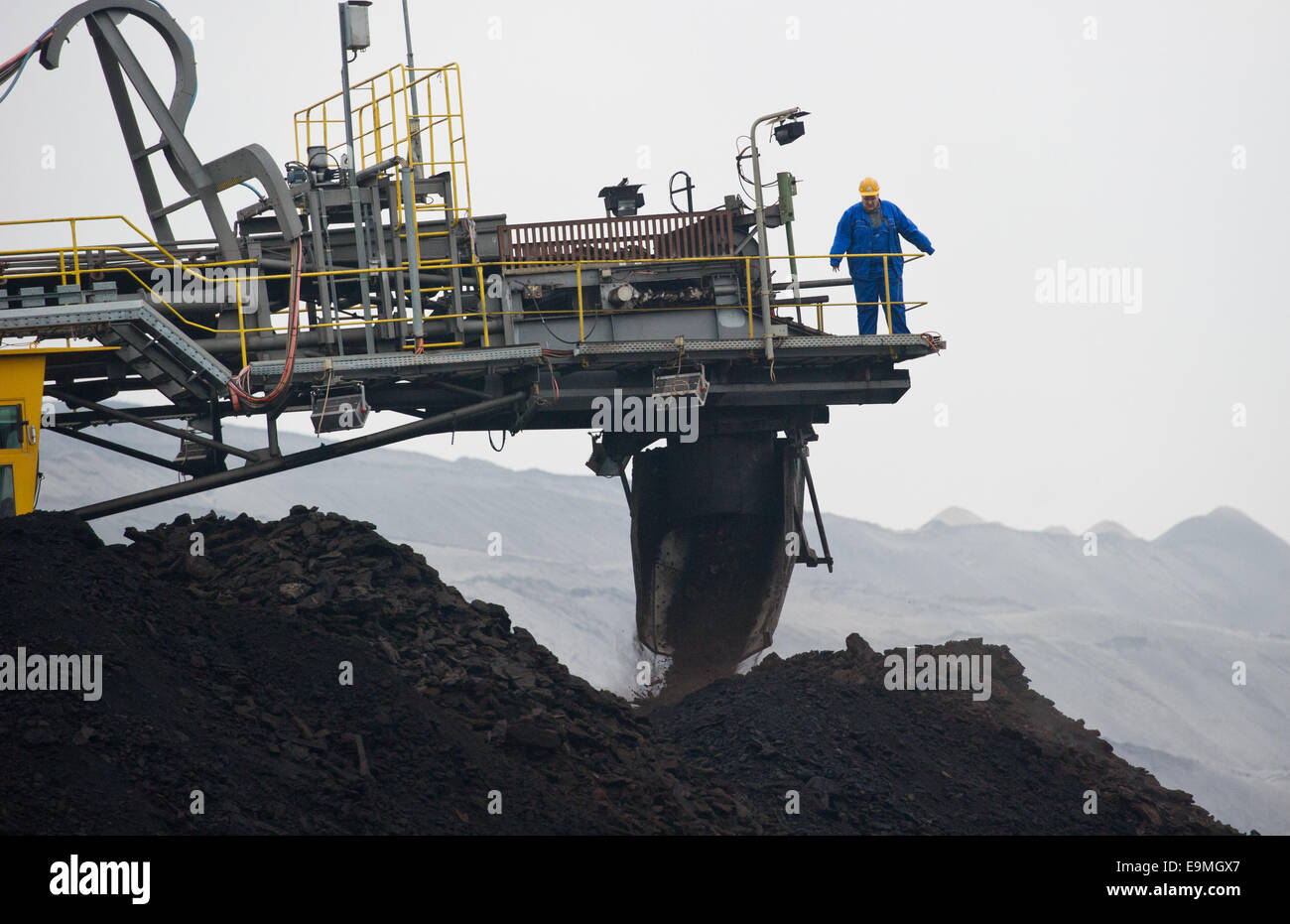 ARCHIVE - A miner stands on a bucket dredger which produces brown coal ...