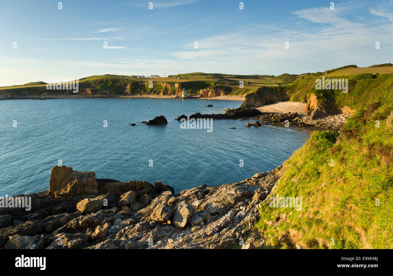 Porth Padrig part of the wider Cemaes Bay with a distant view of St ...