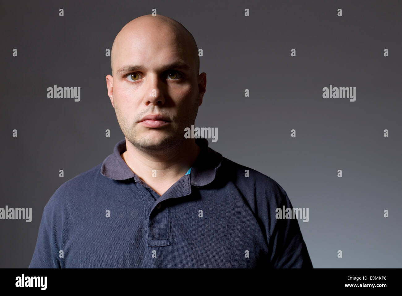 Portrait of young man thinking on a black background Stock Photo - Alamy