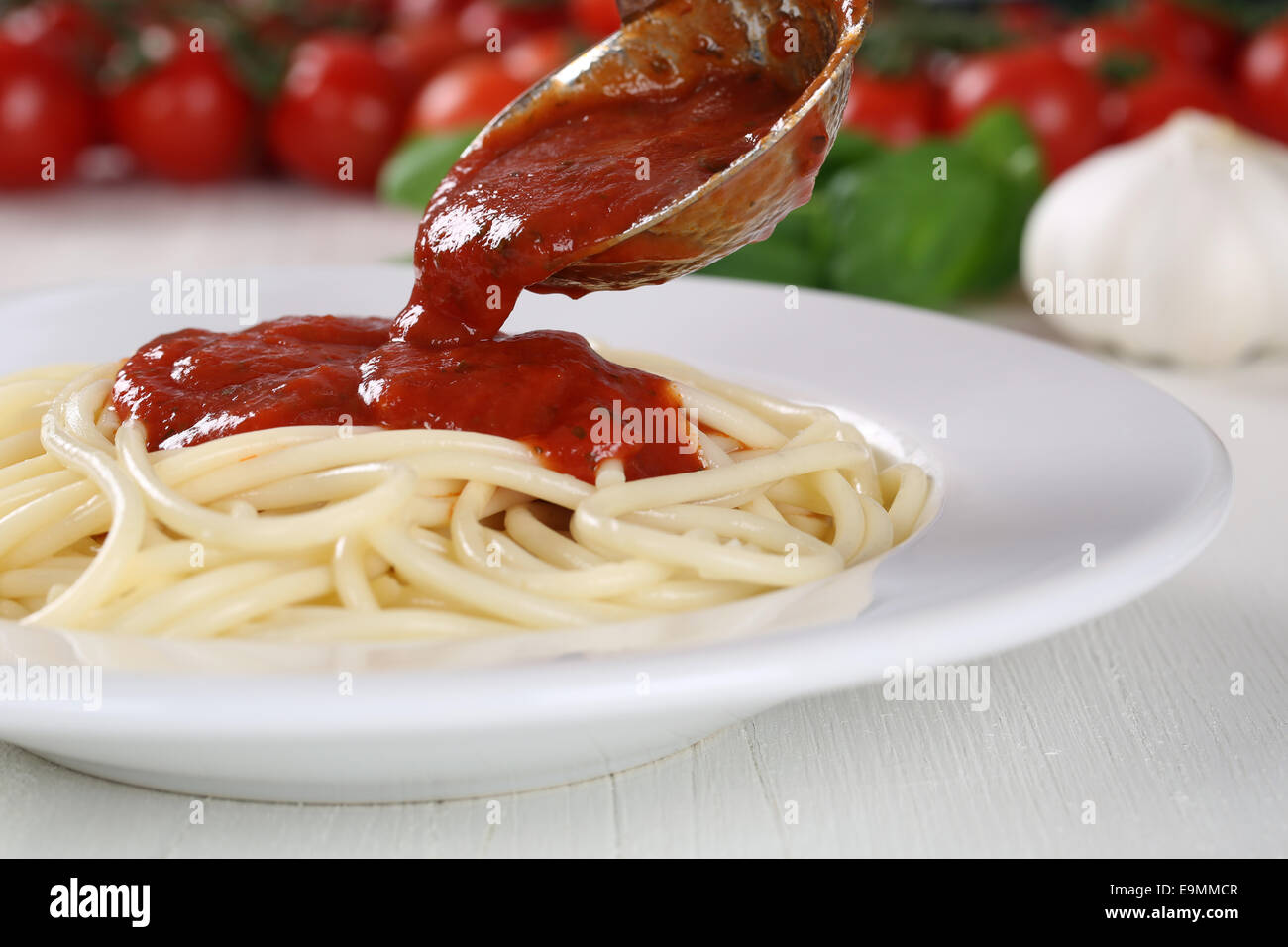 Cooking spaghetti noodles pasta: serving tomato sauce Napoli on plate ...