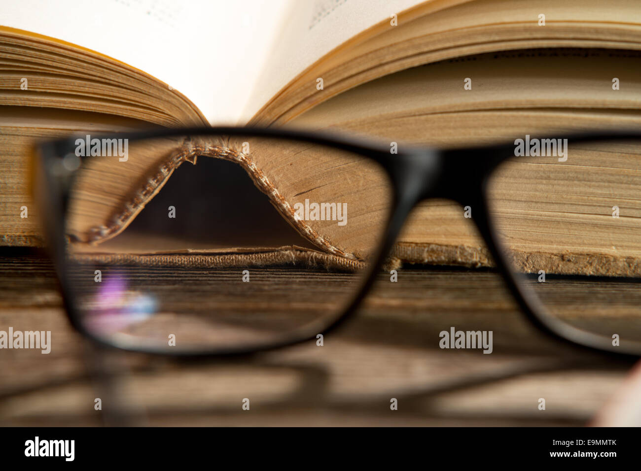 reading glasses with books on the table Stock Photo - Alamy