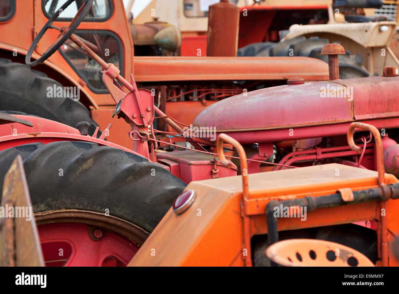 Collection of red and orange tractors Stock Photo - Alamy