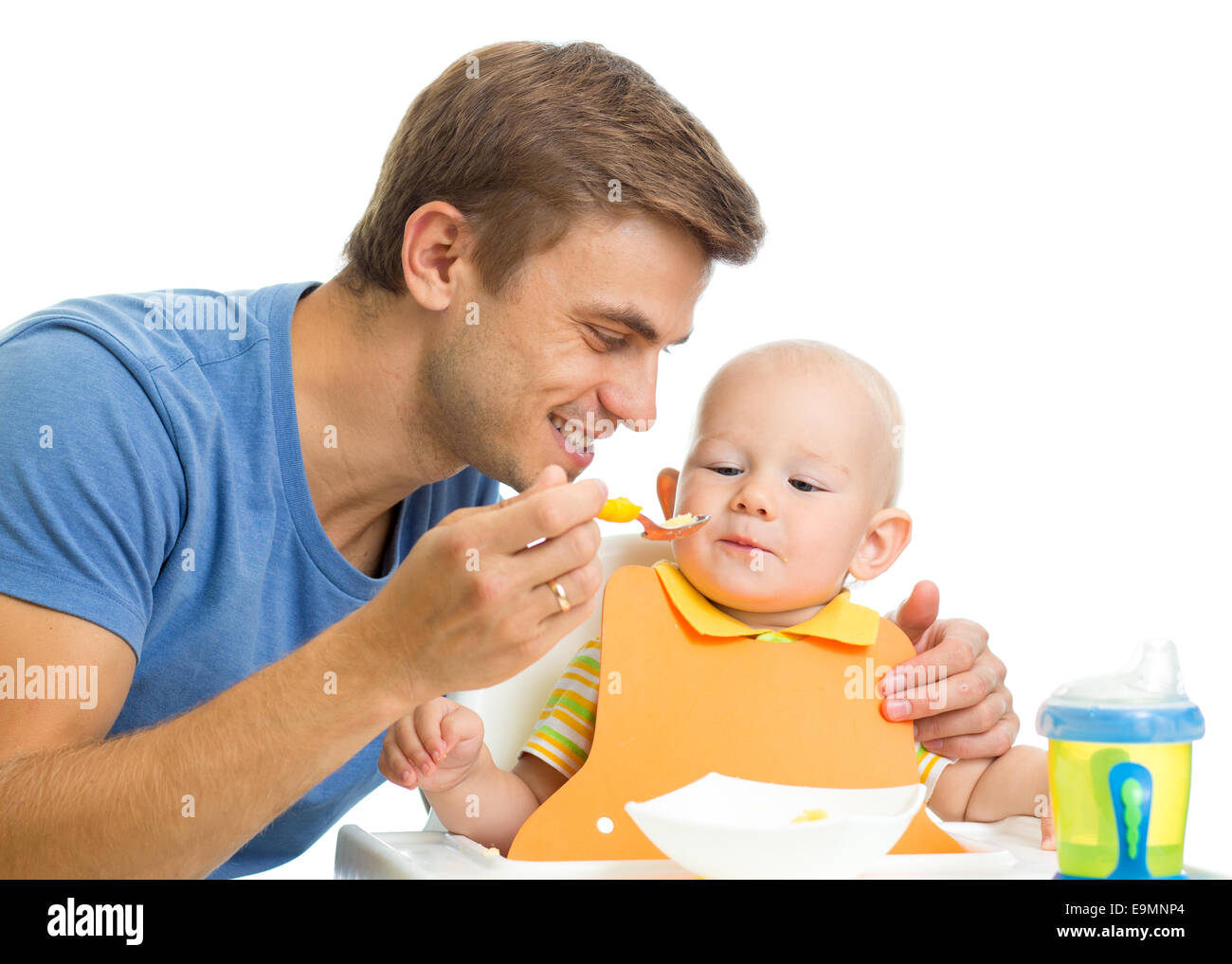 father feeding baby son by healthy food Stock Photo - Alamy