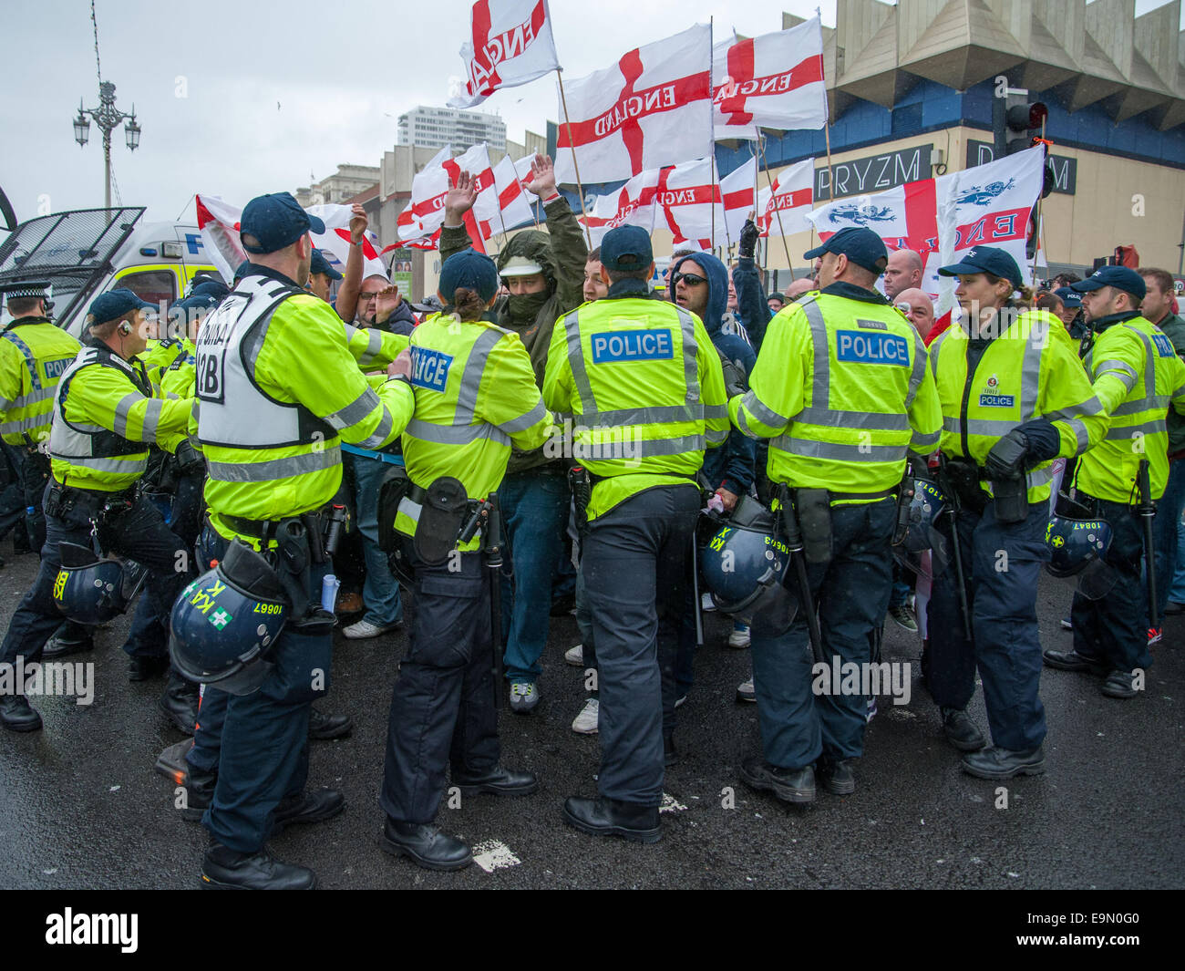 Riot police herd the marchers past Brighton Pier as various far-right ...