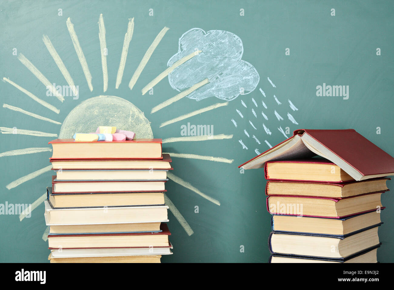 Unusual education concept. School from books on background of chalk ...