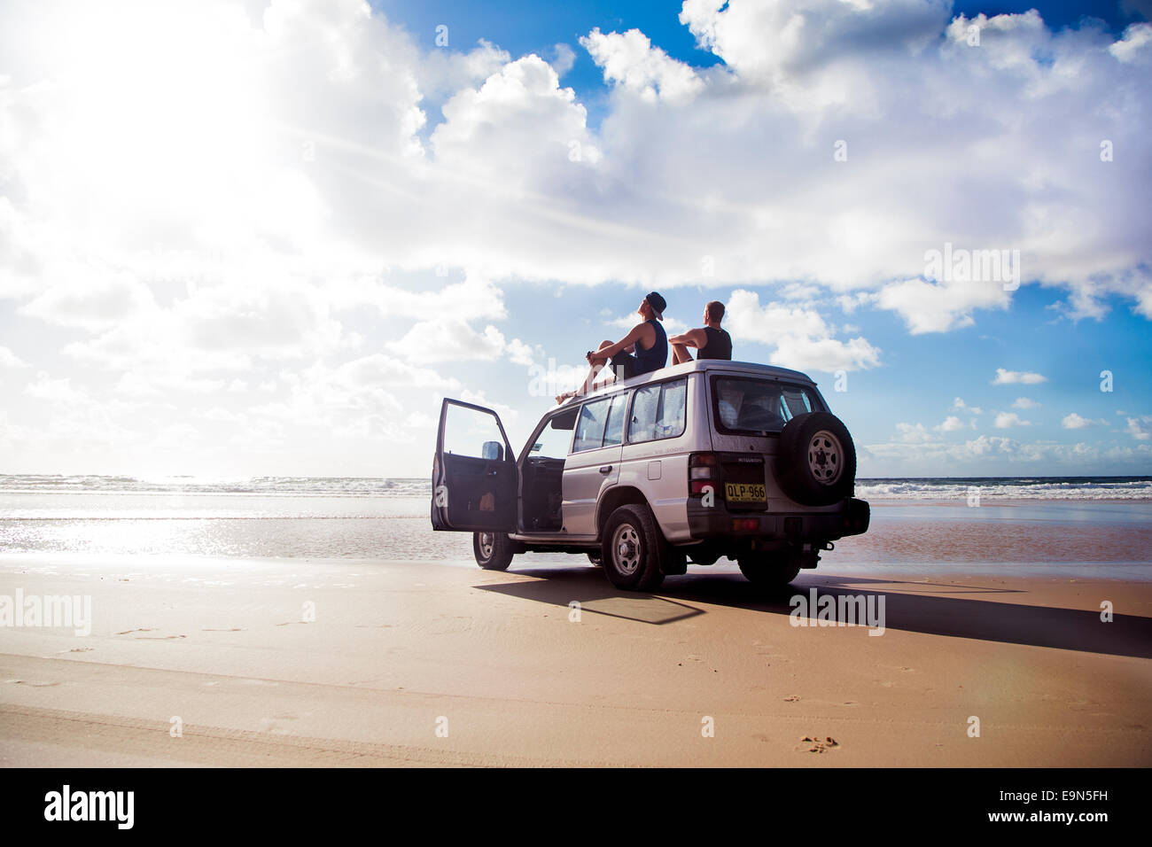 Two men sunbathing on beach hi-res stock photography and images - Alamy