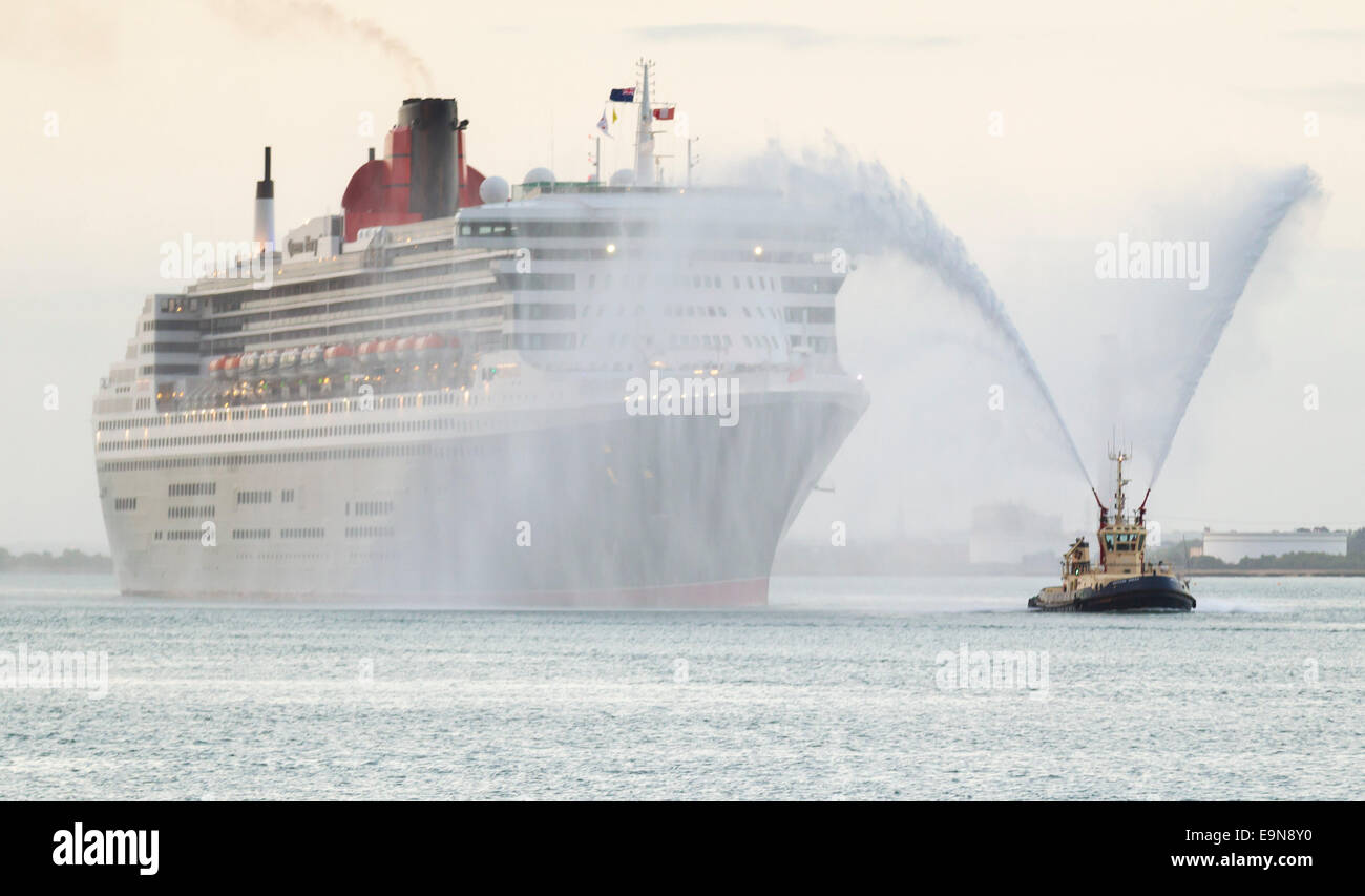 A fire tug sprays jets high into the air to welcome Queen Mary Two to ...