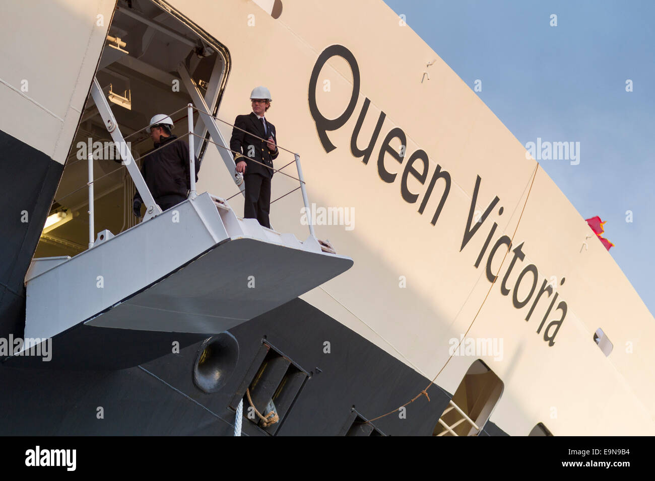 A deck officer looks down from the liner Queen Victoria as the Cunard ...