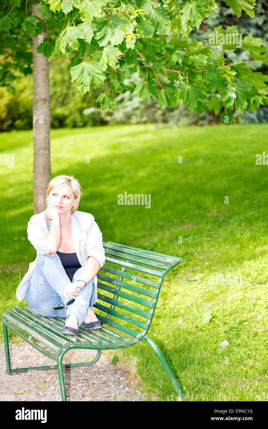 Blonde girl on park bench hi-res stock photography and images - Alamy