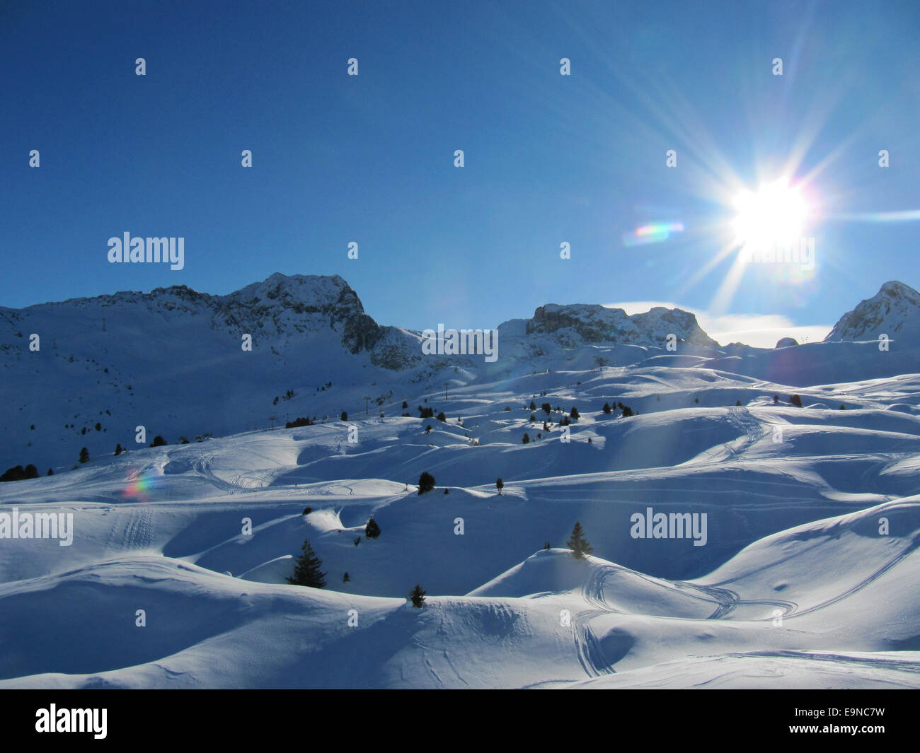winter alpine mountain scene under a blue sky Stock Photo - Alamy