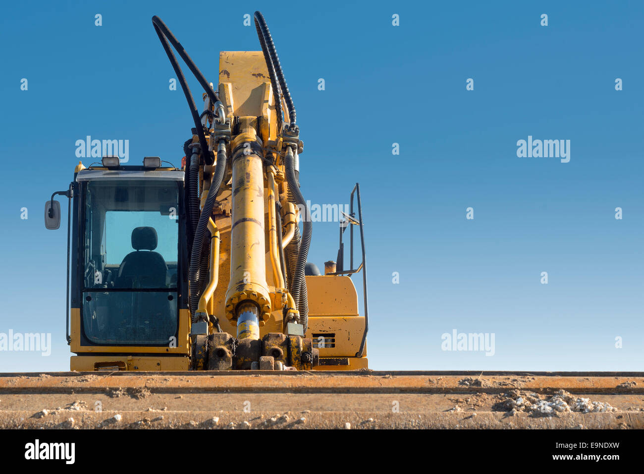front close view of excavator on blue sky background Stock Photo - Alamy