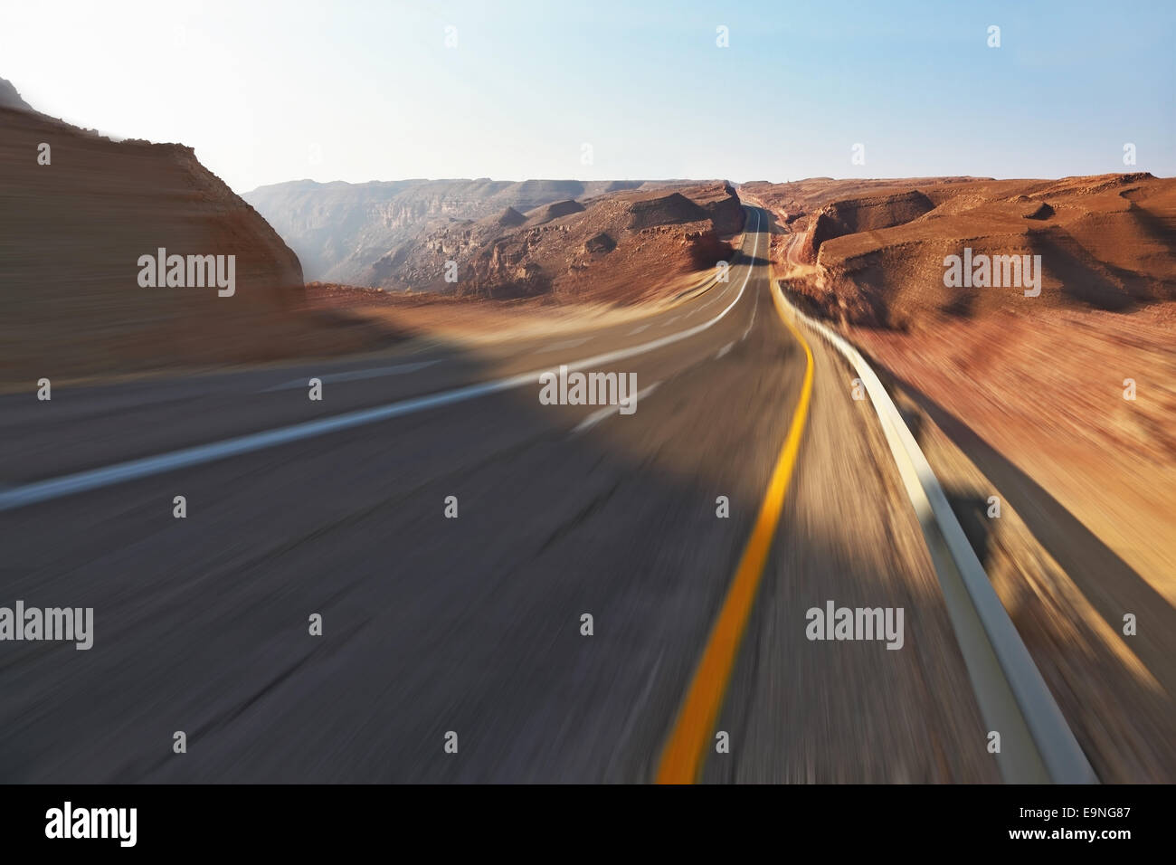 Trip driving on high speed in stone desert Stock Photo - Alamy